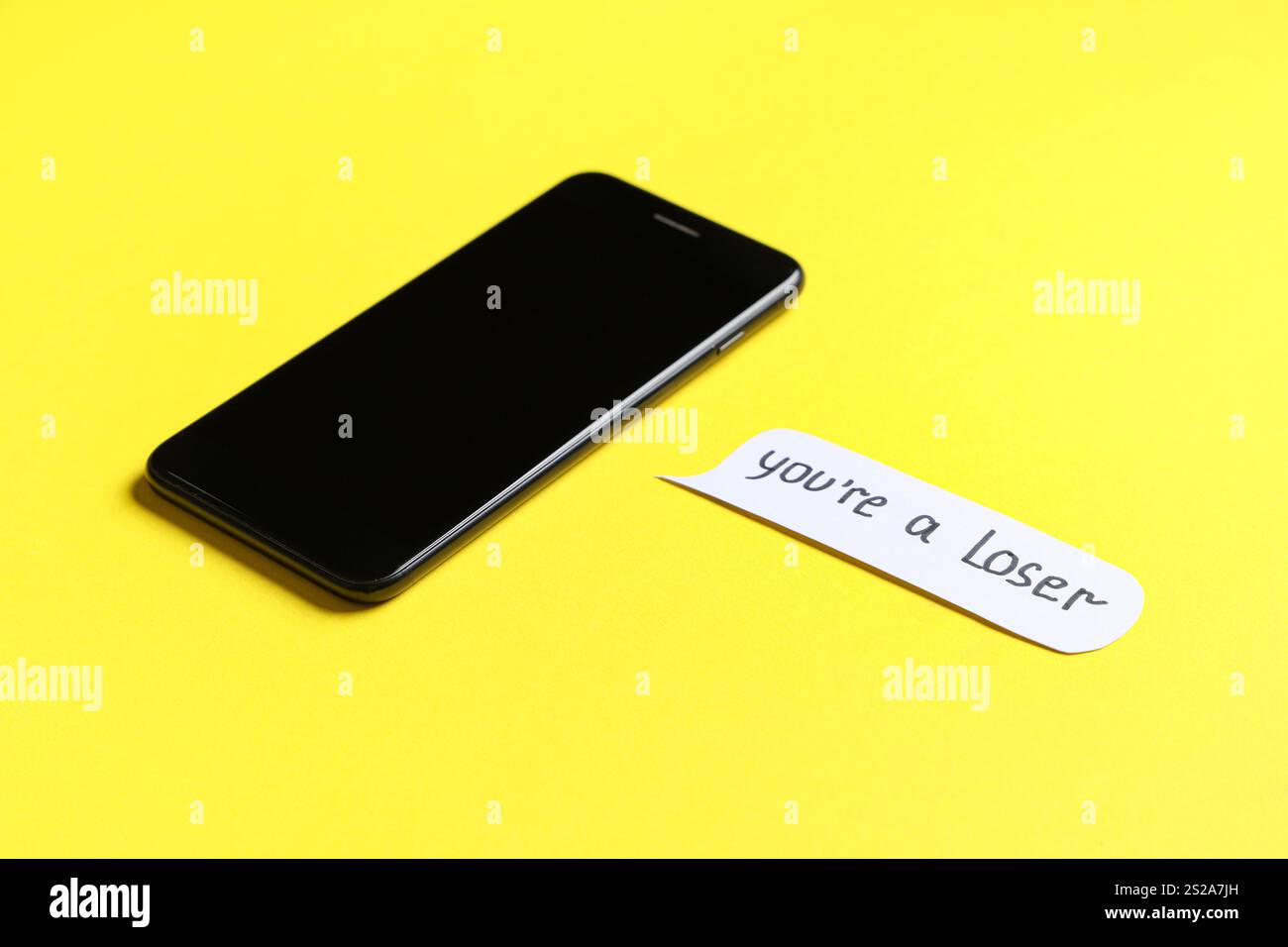 Speech bubble with text YOU'RE LOSER and blank mobile phone on yellow ...
