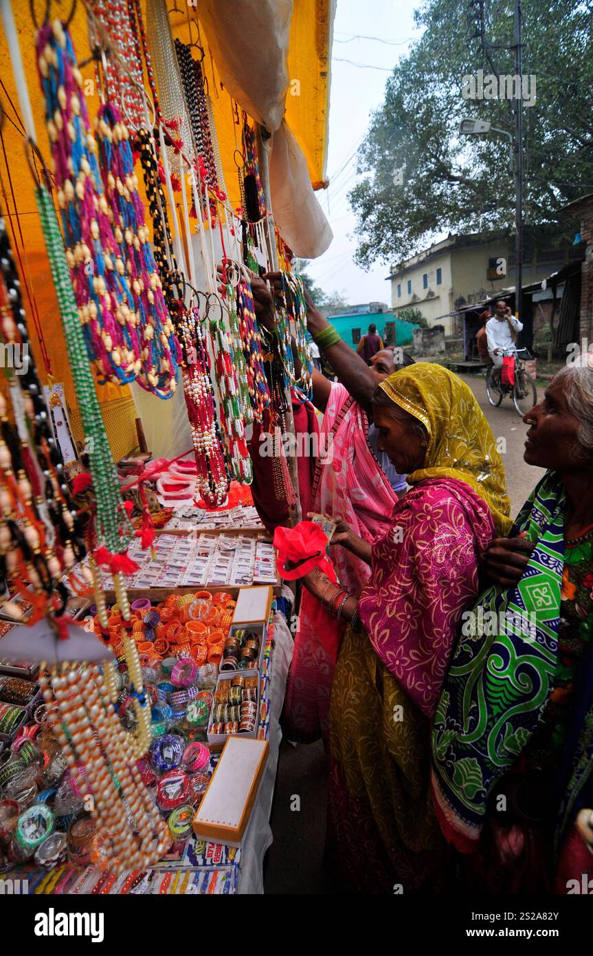 Indian women shopping in a small jewelry shop at the market in Ayodhya ...