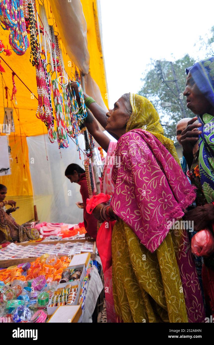 Indian women shopping in a small jewelry shop at the market in Ayodhya ...