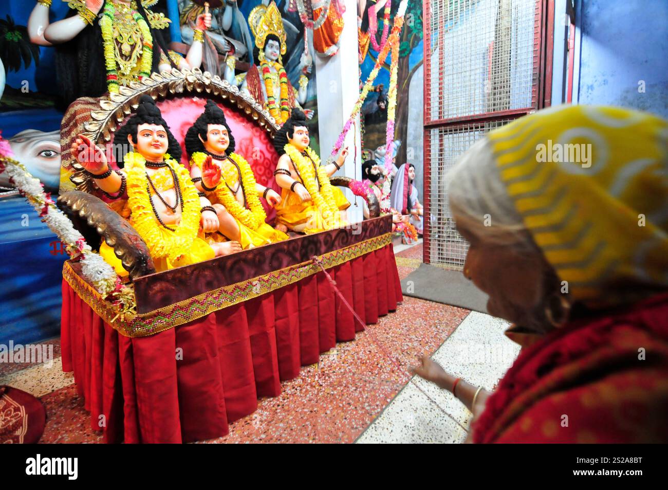 A Hindu pilgrim praying at a small temple dedicated to lord Rama in ...