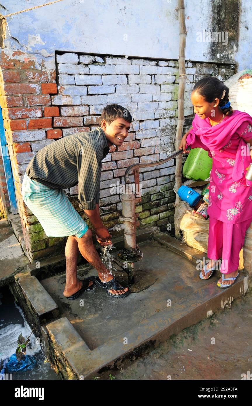 A woman pumping water from a borewell in Ayodhya, Uttar Pradesh, India ...