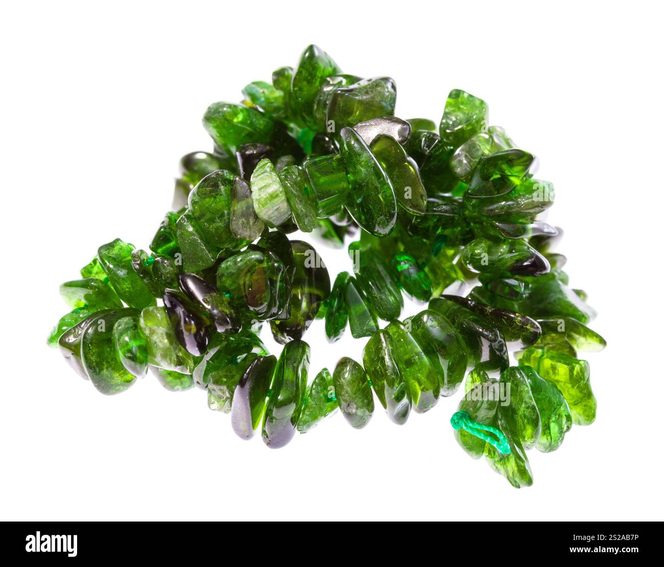 tangled string of beads from natural tumbled chrome diopside gemstone isolated on white ...