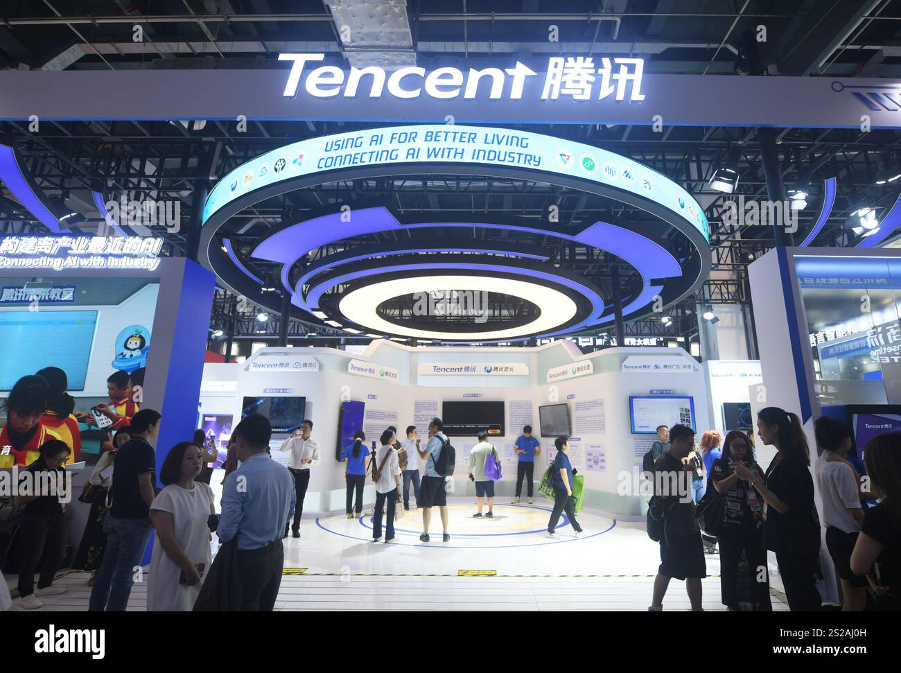 Visitors visit the stand of Tencent at the World Artificial ...