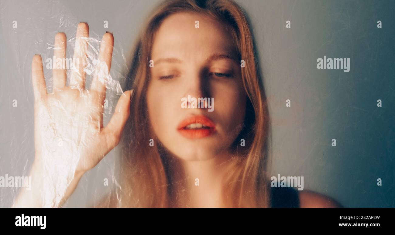 Female isolation. Sadness art. Sensual disturbed woman standing behind ...