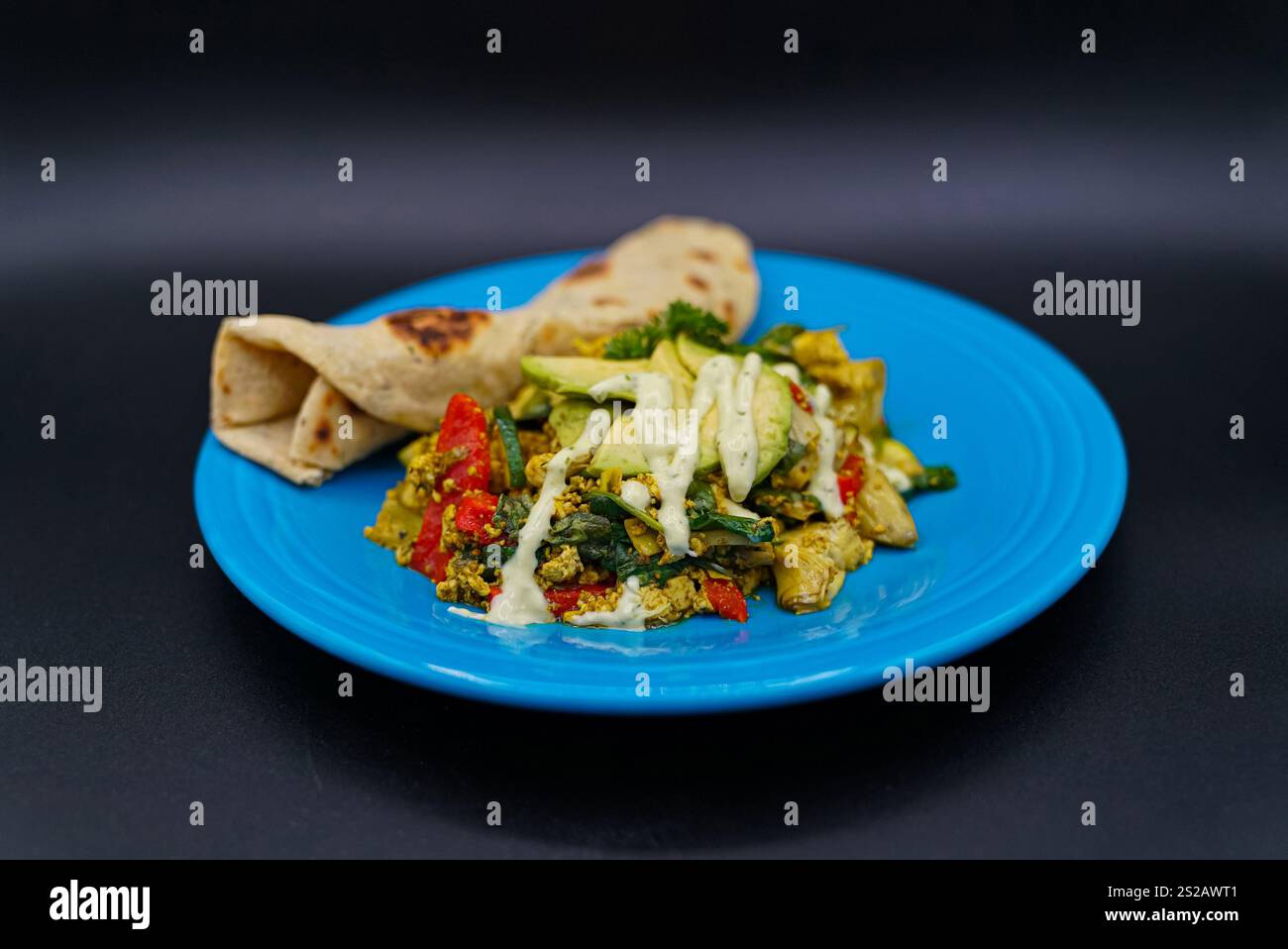 Colorful Vegetable Stir-Fry with Avocado and Homemade Roti Stock Photo ...