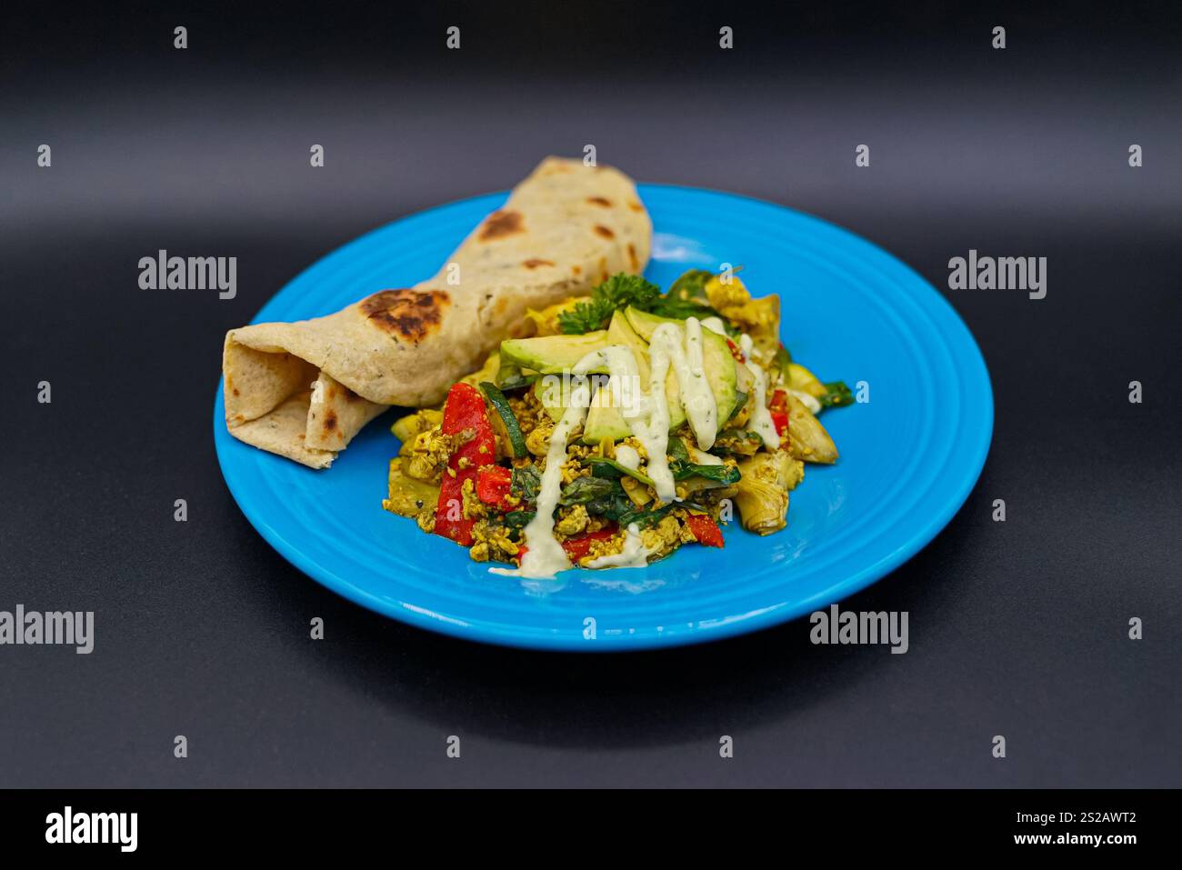 Colorful Vegetable Stir-Fry with Avocado and Homemade Roti Stock Photo ...