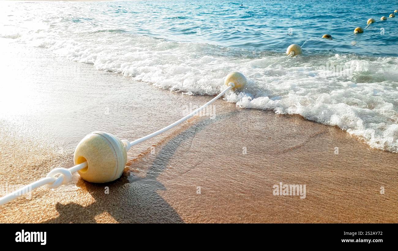 Closeup beautiful photo of long line of floating buoys connected by ...