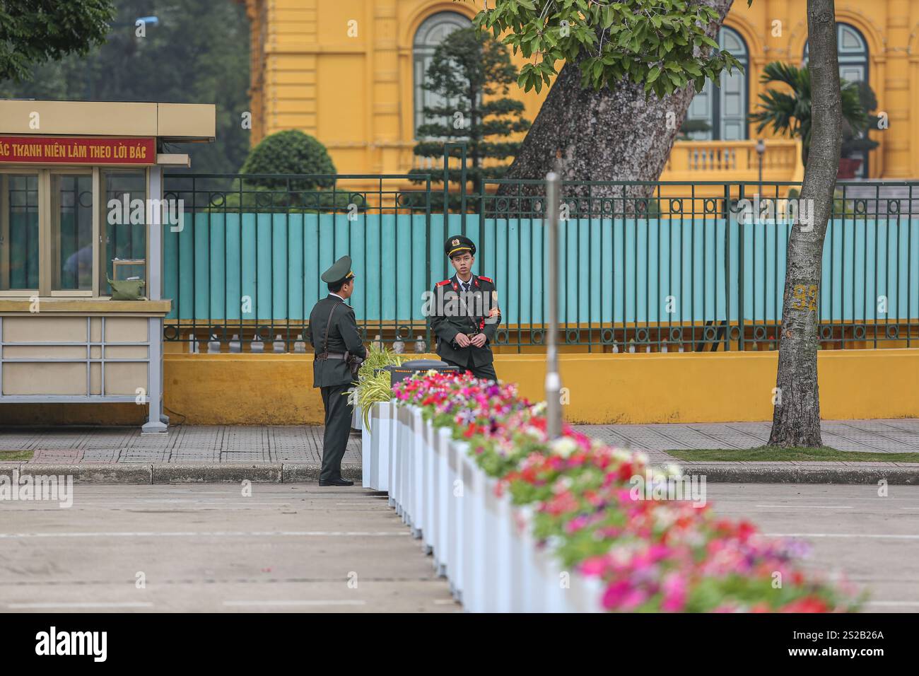 Vietnamese policemen guard the Presidential Palace of Vietnam in Hanoi ...