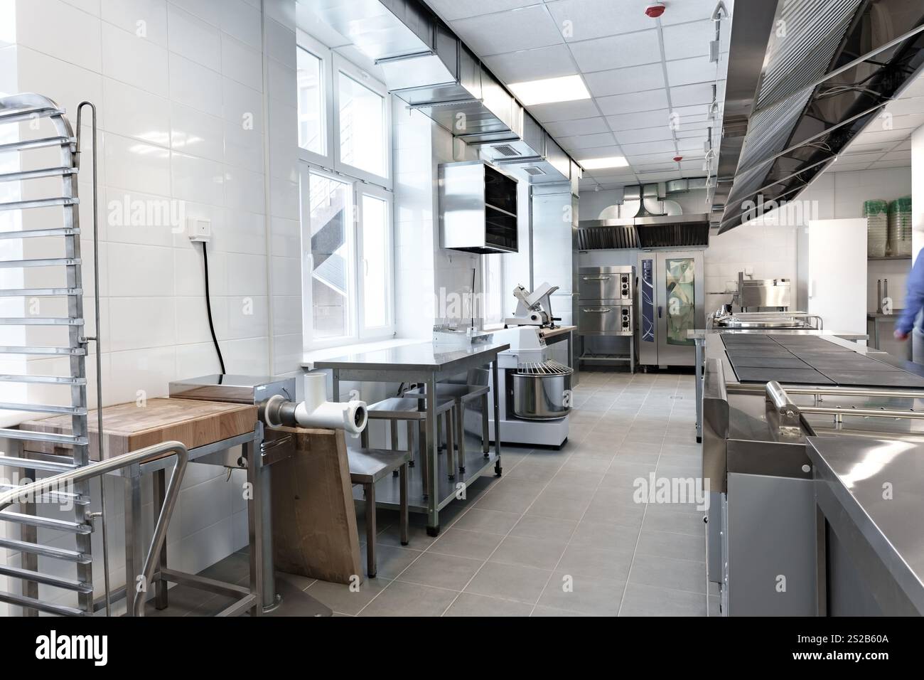Modern commercial kitchen interior featuring stainless steel appliances ...