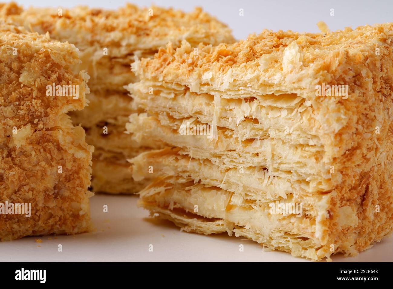 Delicate layers of puff pastry filled with cream displayed on a simple ...