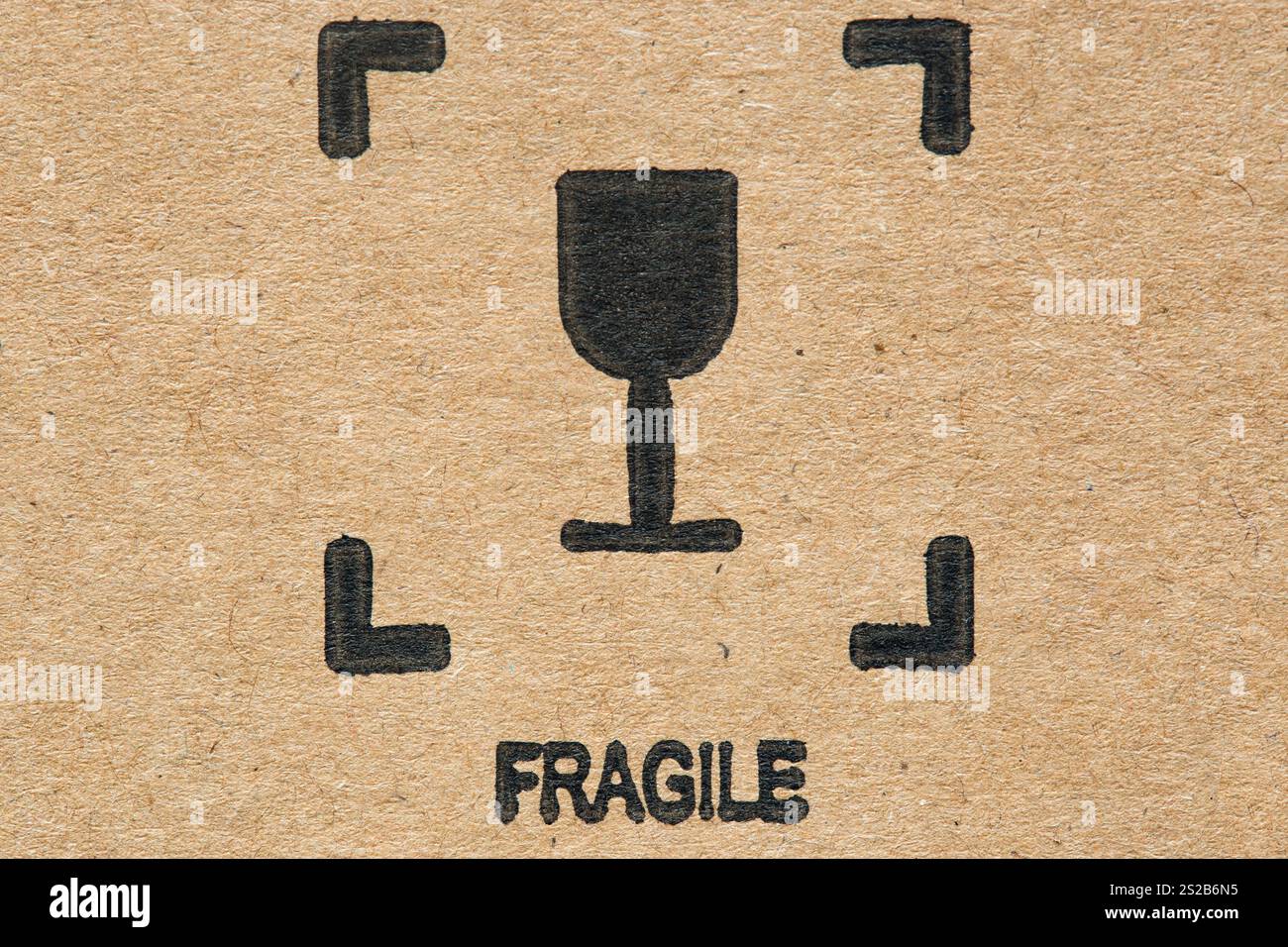 Fragile warning printed on a cardboard box background. Cargo freight delivery warning concept ...