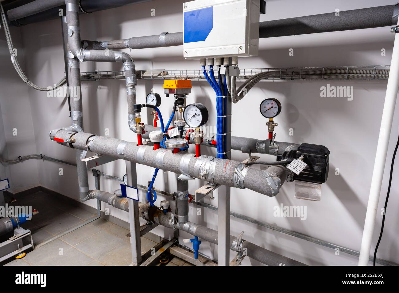 Piping system installation in a modern industrial facility with gauges ...