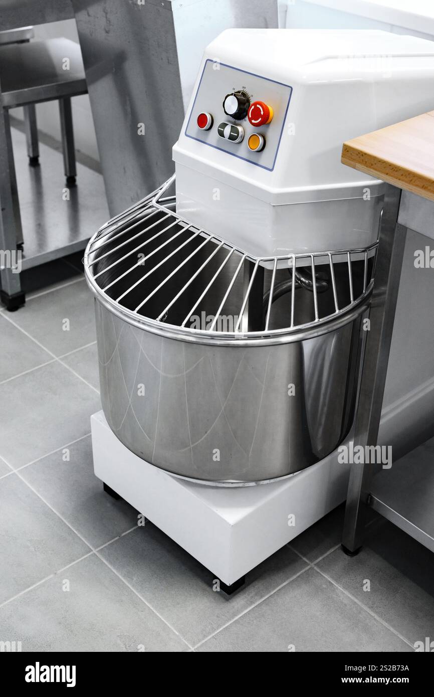 Industrial dough mixer in a modern kitchen setting with a stainless ...