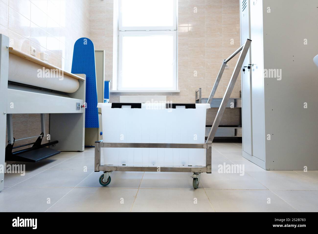 Clean and modern workspace featuring a rolling cart in a well-lit room ...