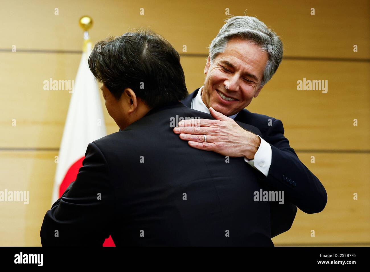 U.S. Secretary of State Antony Blinken embraces Japanese Chief Cabinet ...