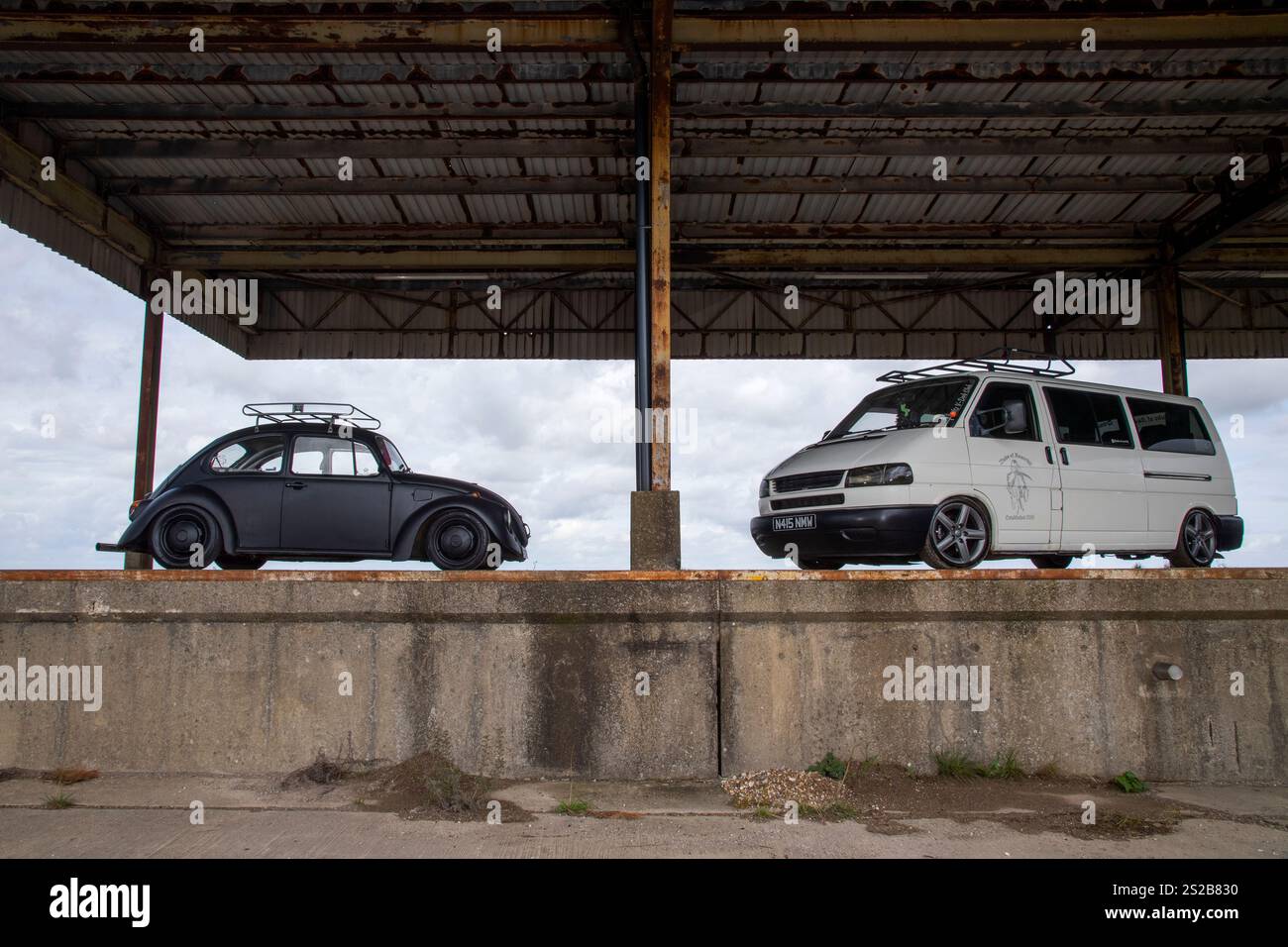 Slammed VW T4 camper van and modified classic VW Beetle Stock Photo - Alamy