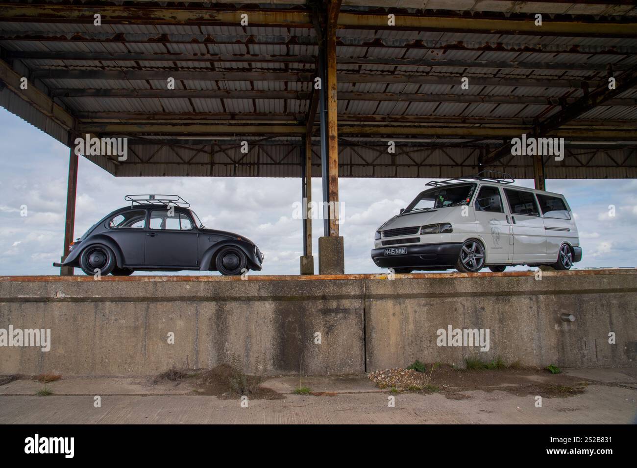 Slammed VW T4 camper van and modified classic VW Beetle Stock Photo - Alamy