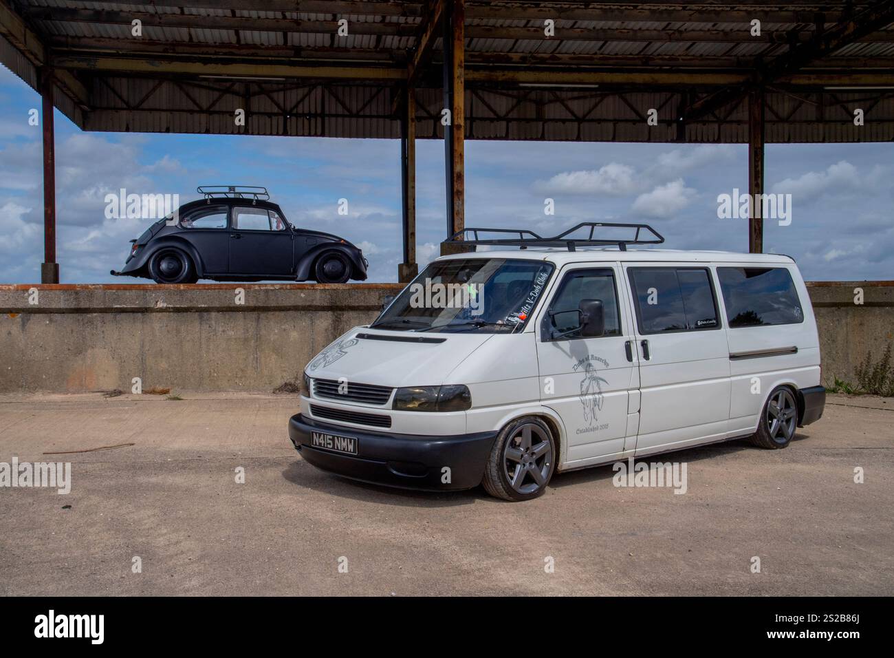 Slammed VW T4 camper van and modified classic VW Beetle Stock Photo - Alamy