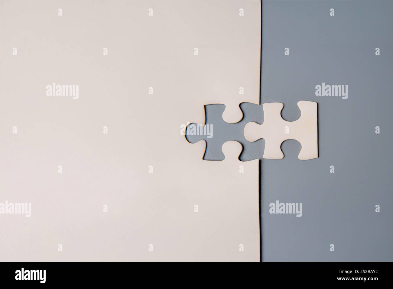 Two puzzle pieces fitting perfectly together, one on a white background ...