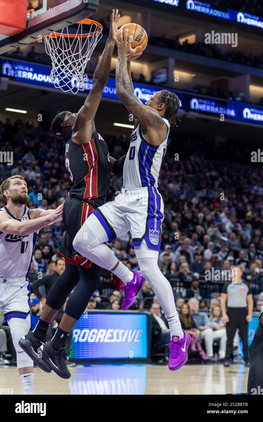 Sacramento Kings forward DeMar DeRozan, right, draws the foul on Miami Heat center Bam Adebayo ...