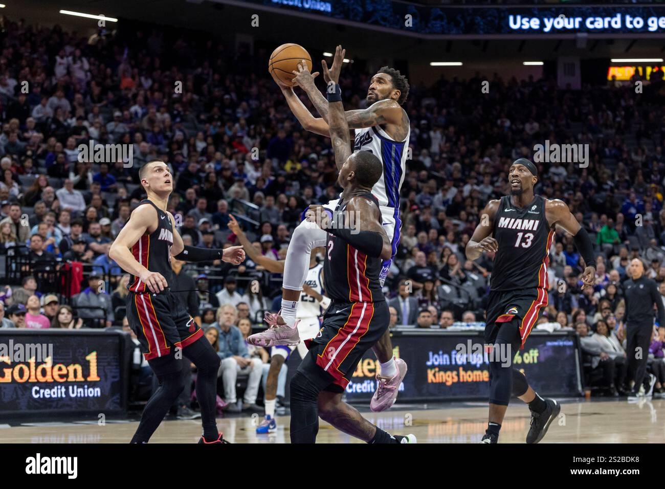 Sacramento Kings guard Malik Monk, center, makes a layup over Miami ...