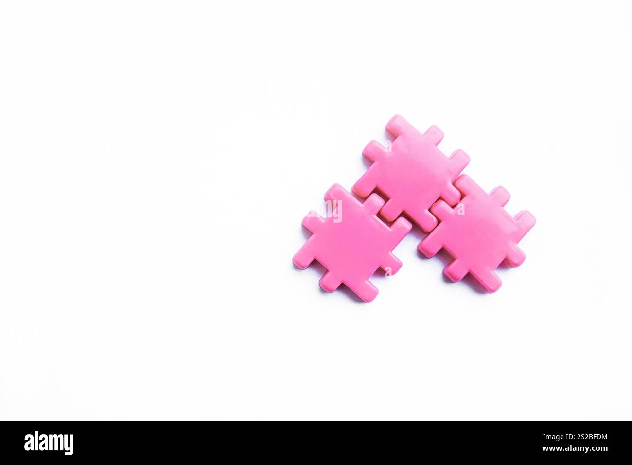 Three pink puzzle pieces perfectly connected, forming a seamless unity ...