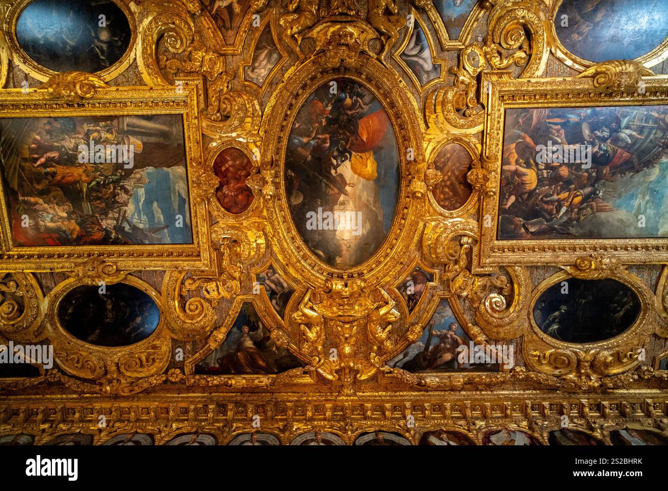 An opulent ceiling featuring elaborate gold frames and detailed ...