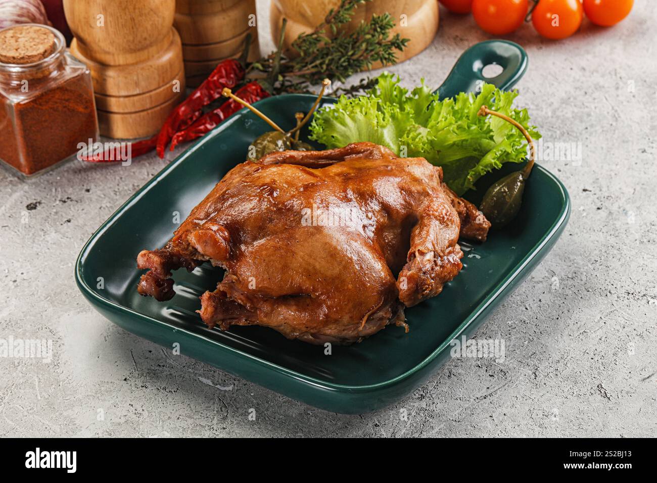 Baked whole small chicken with spices Stock Photo - Alamy