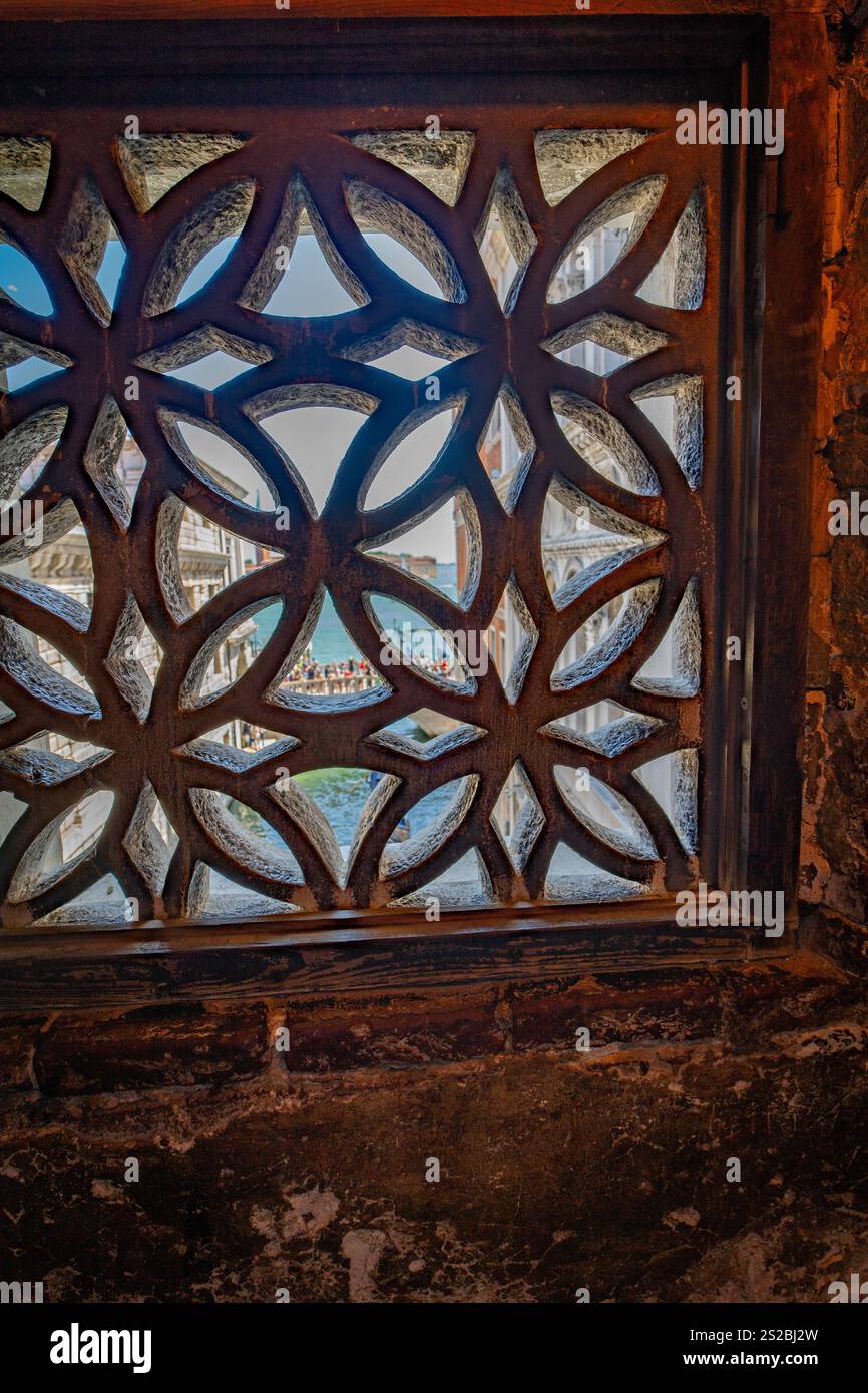An intricate stone lattice window inside the Bridge of Sighs in Venice ...