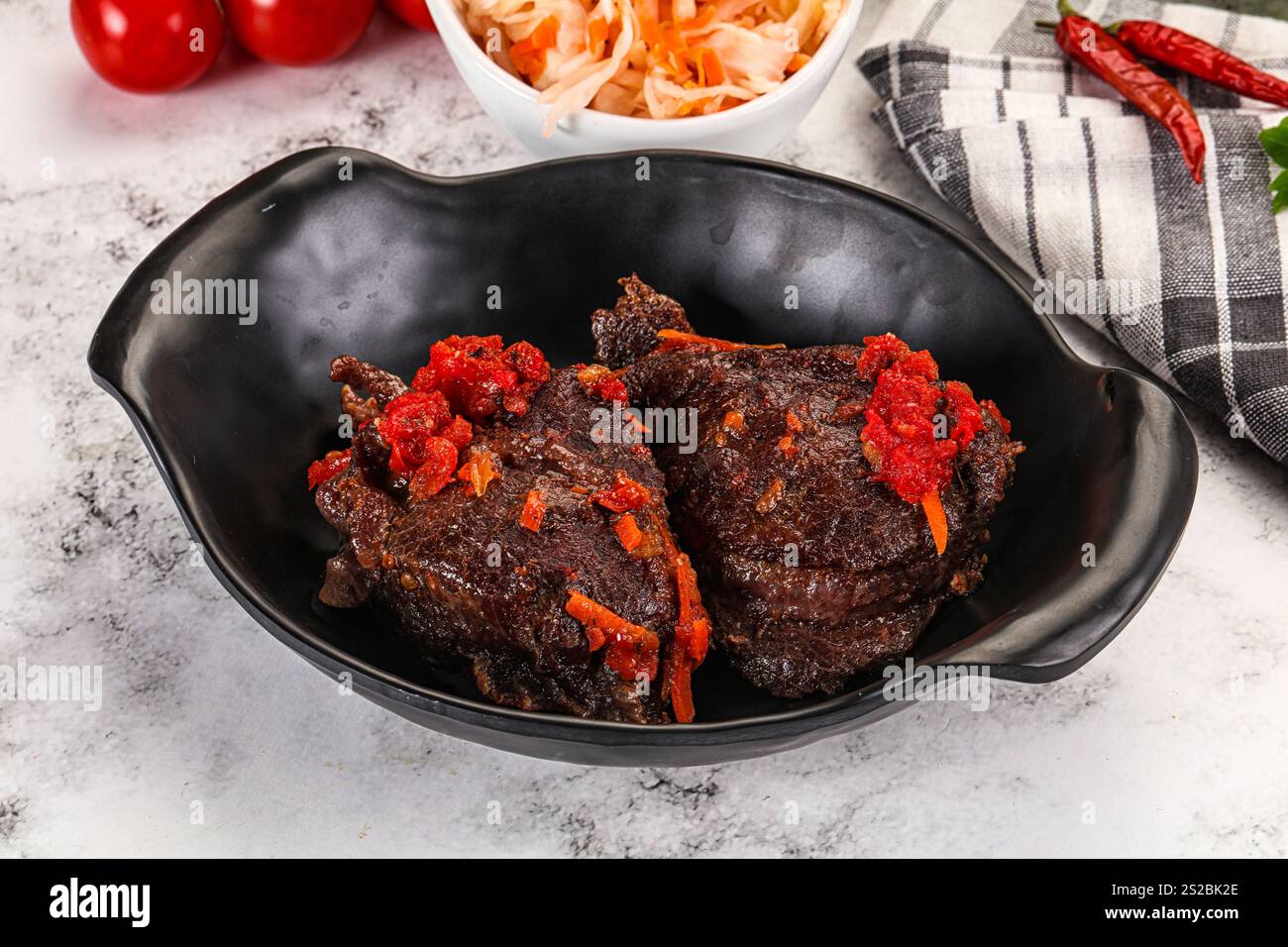 Baked beef cheeks with vegetables and spices Stock Photo - Alamy