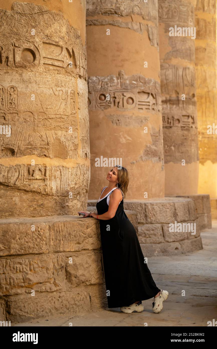 A girl stands and looks at a column in an ancient cornac Stock Photo ...