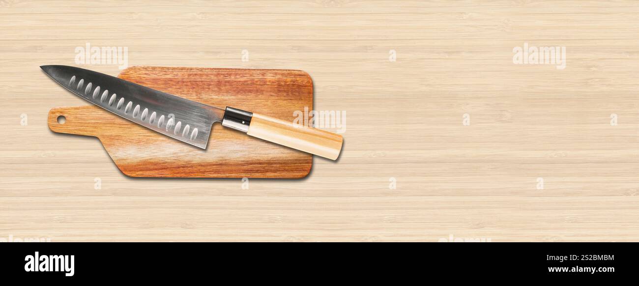 Traditional Japanese gyuto chief knife on a cutting board. Wooden ...