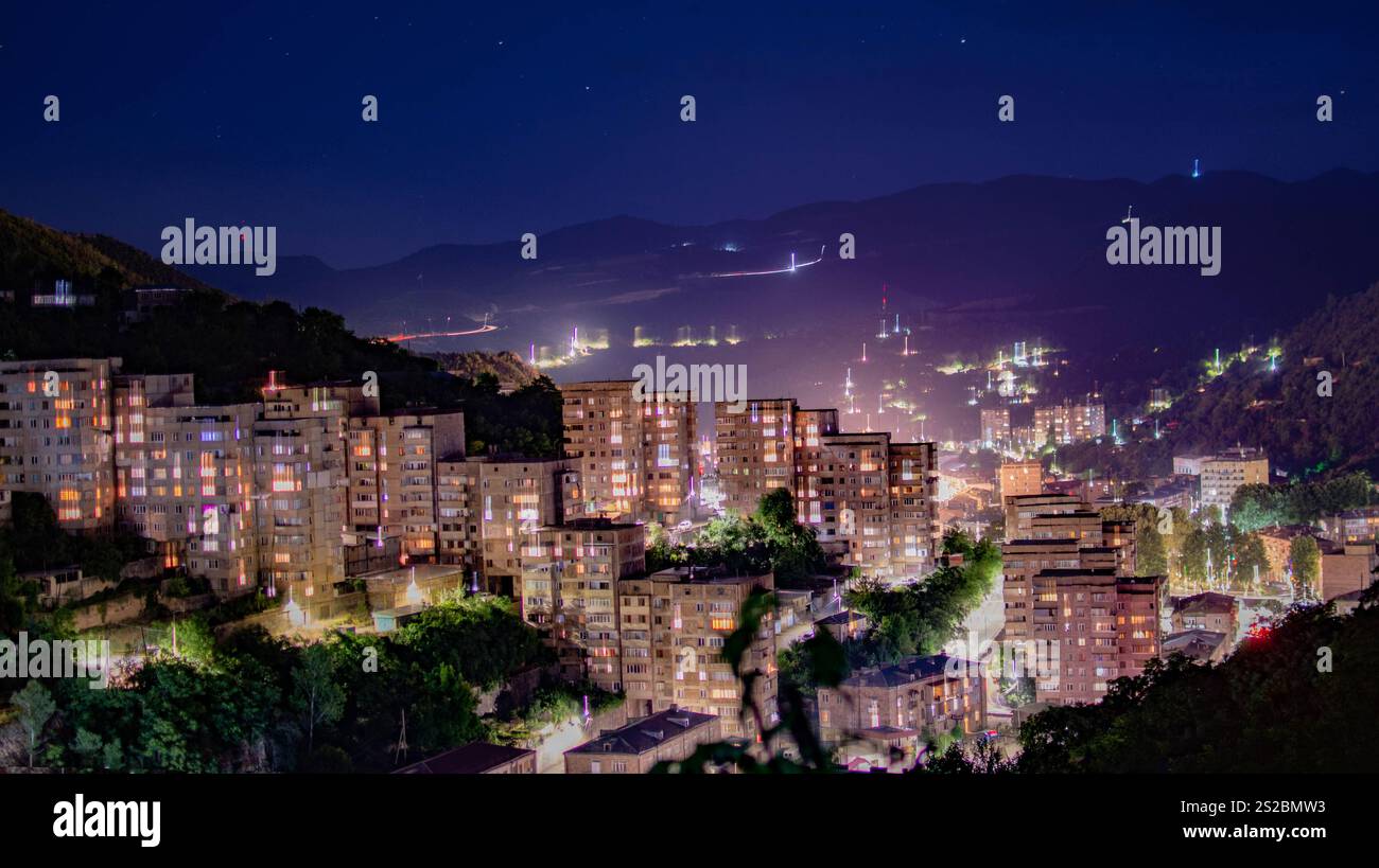 Night city life. Lights of buildings. Cars traffic lights. River over ...