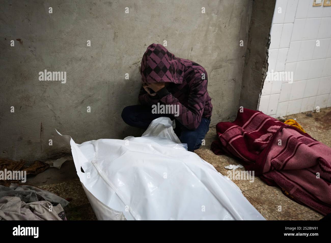 A man mourn over the bodies of two members of Abeid family who were killed in the Israeli ...
