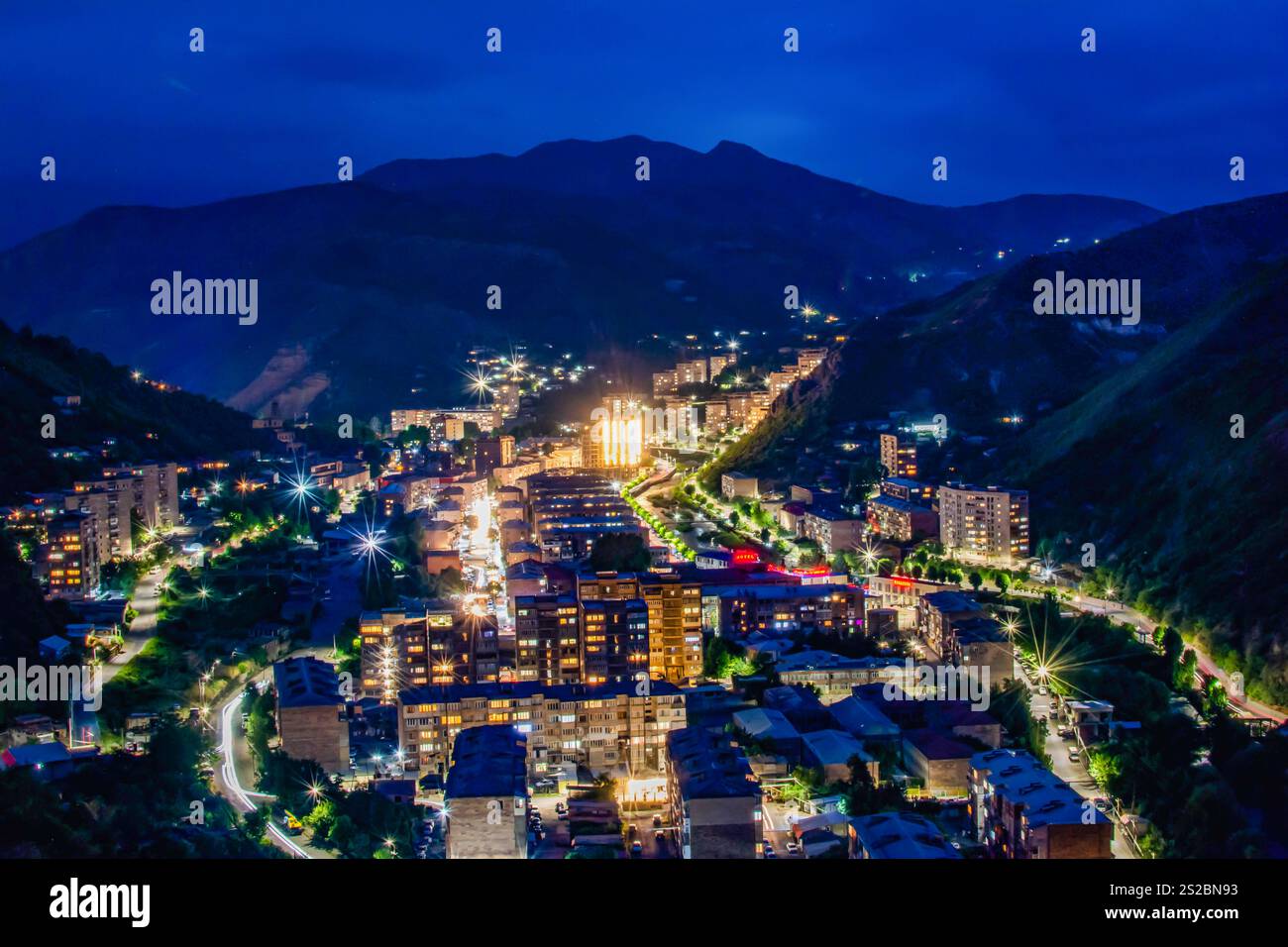 Night city from a bird's eye view. The light of houses and cars. A ...