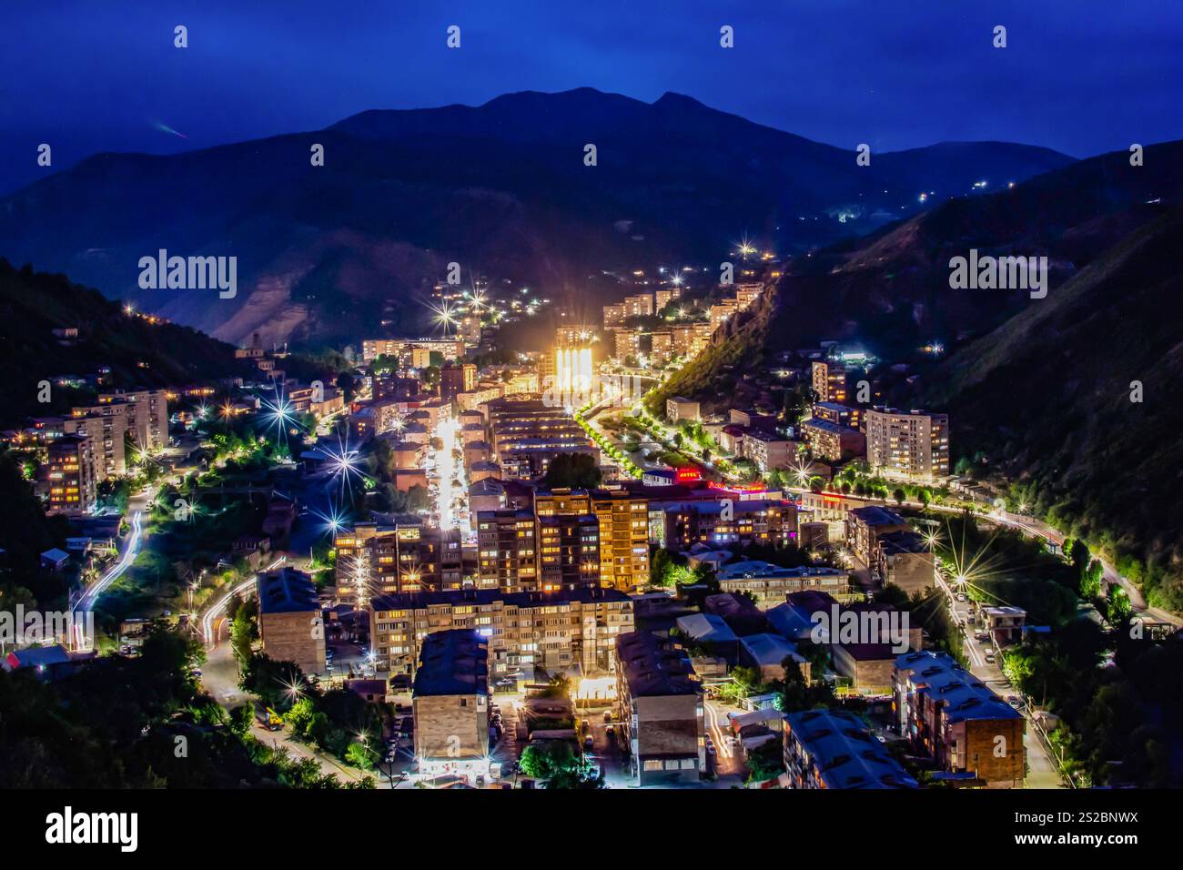 Night city from a bird's eye view. The light of houses and cars. A ...
