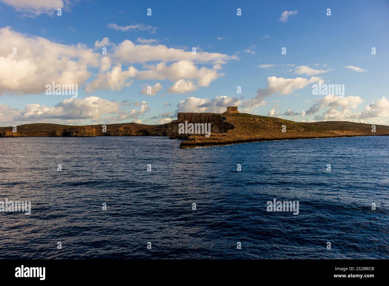 Tranquil ocean view with distant island under scattered clouds in the ...