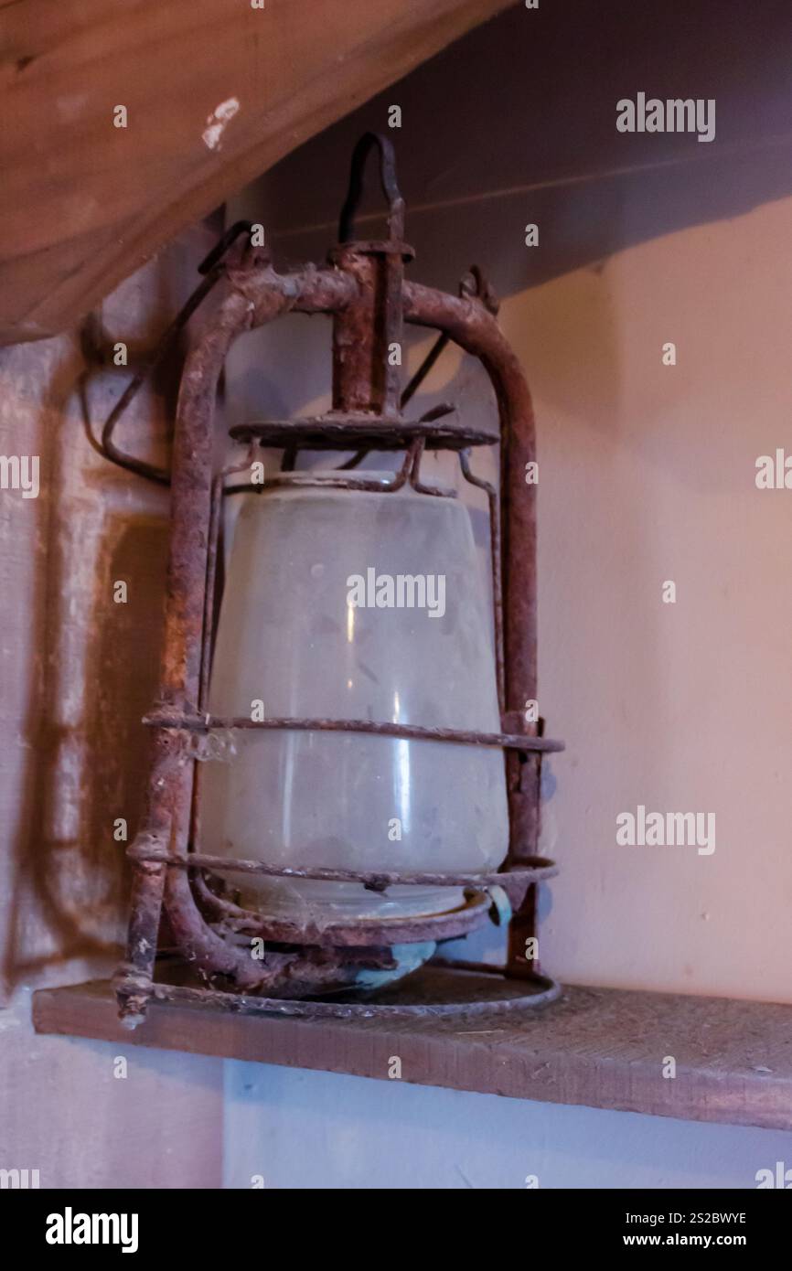 Vintage lantern captured in a quaint indoor setting, evoking a sense of ...