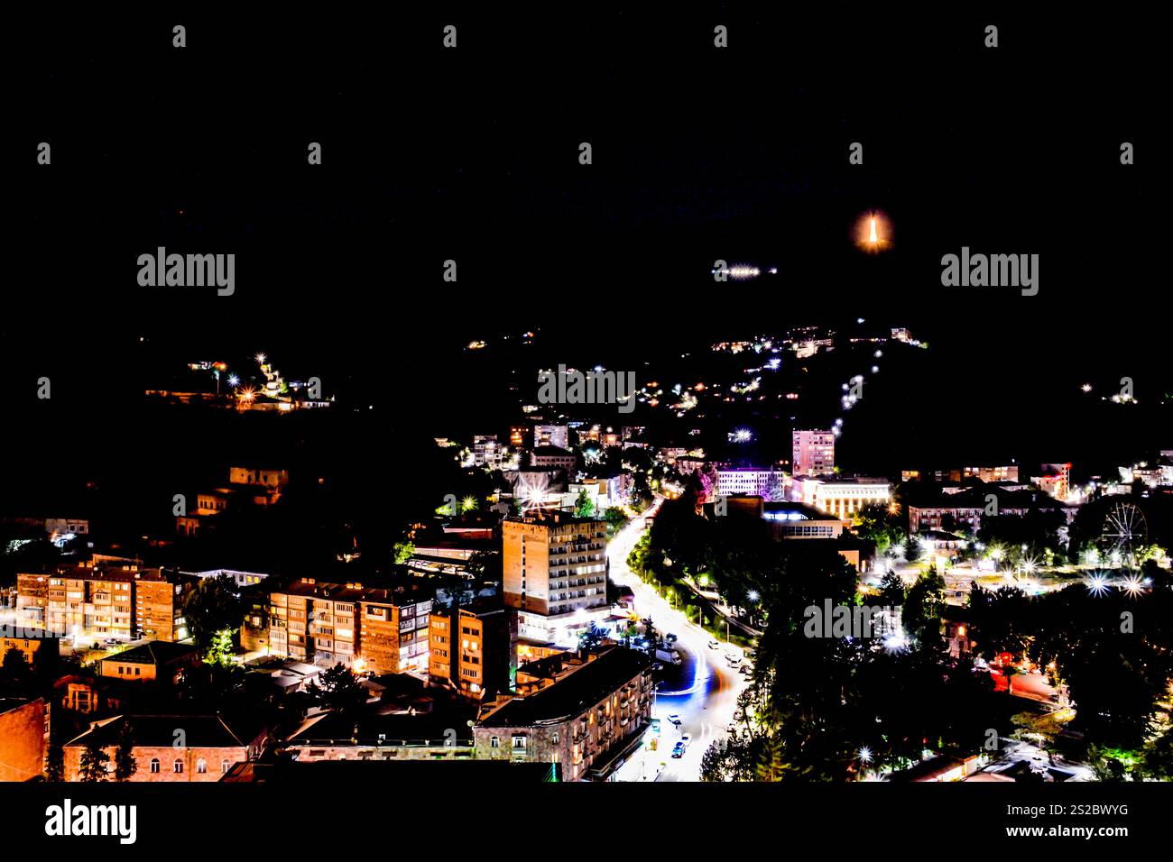 Night city life. Lights of buildings. Cars traffic lights. River over ...