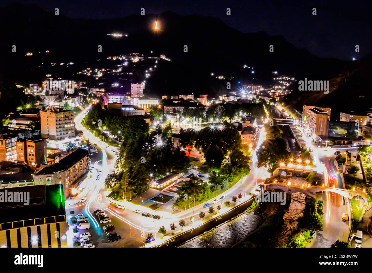 Night city life. Lights of buildings. Cars traffic lights. River over ...