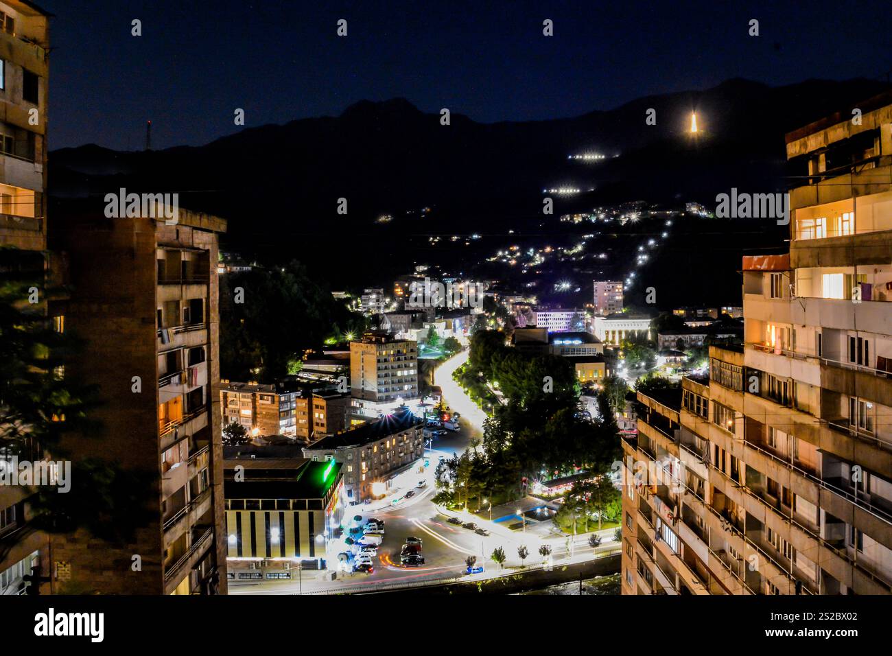 Night city life. Lights of buildings. Cars traffic lights. River over ...