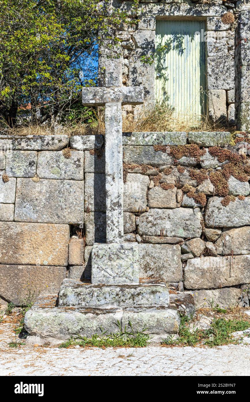 Religious granite christianity cross in font of granite wall with moss ...