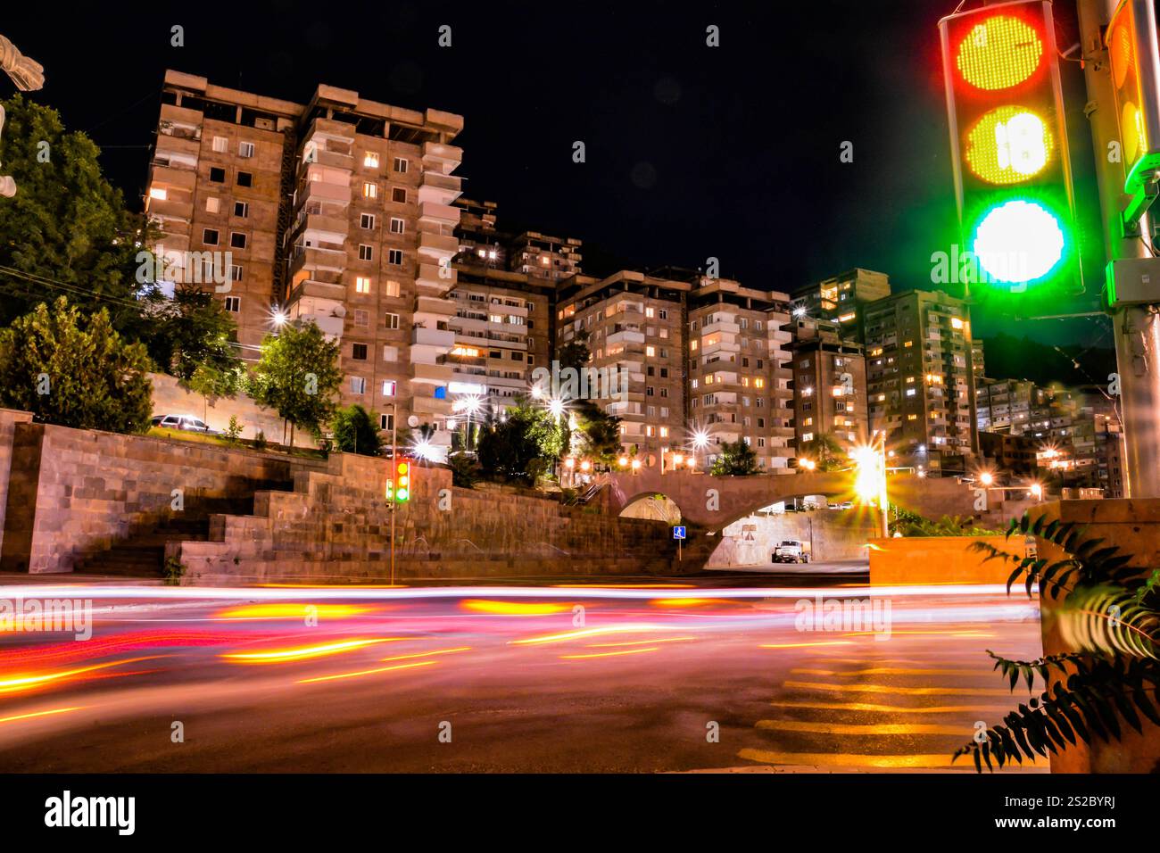 Night city life. Lights of buildings. Cars traffic lights. River over ...