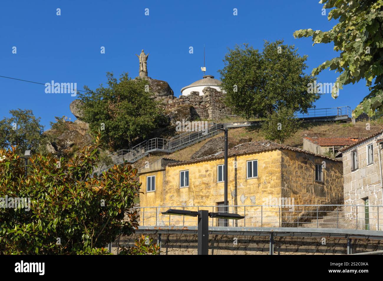 Remains of a castle now with a statue of Jesus praying to heaven and ...