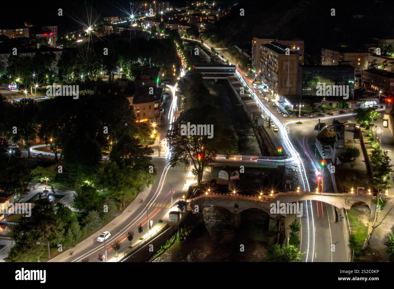 Night city life. Lights of buildings. Cars traffic lights. River over ...