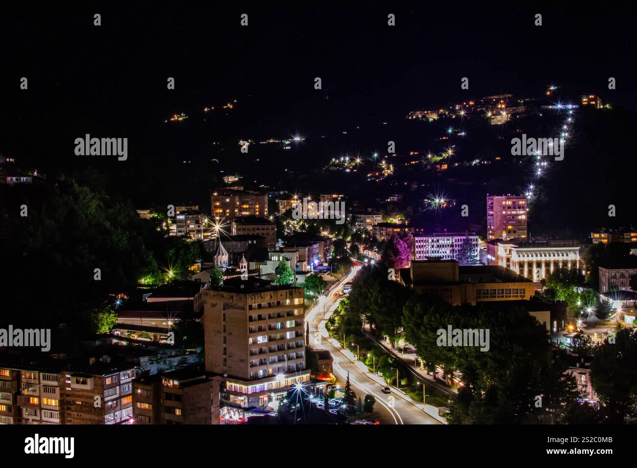 Night city life. Lights of buildings. Cars traffic lights. River over ...
