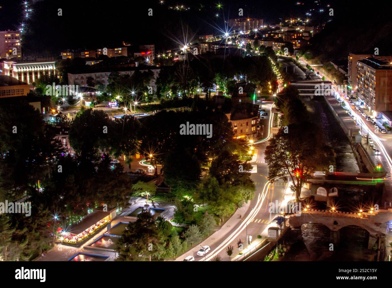 Night city life. Lights of buildings. Cars traffic lights. River over ...