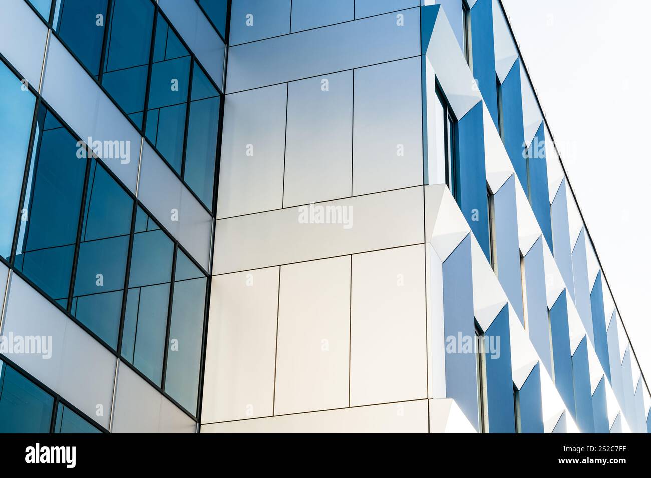 Modern Geometric Glass and Metal Facade with Blue-Tinted Windows in Contemporary Design Stock ...