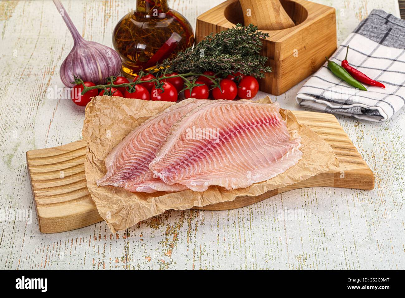 Raw Tilapia fish fillet slice uncooked Stock Photo - Alamy