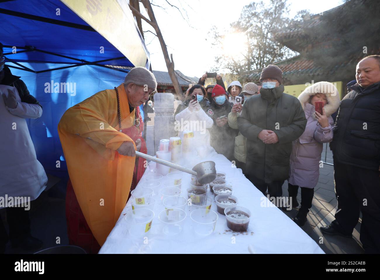 Beijing,China.7th January 2025. A Buddhist monk distributes Laba ...